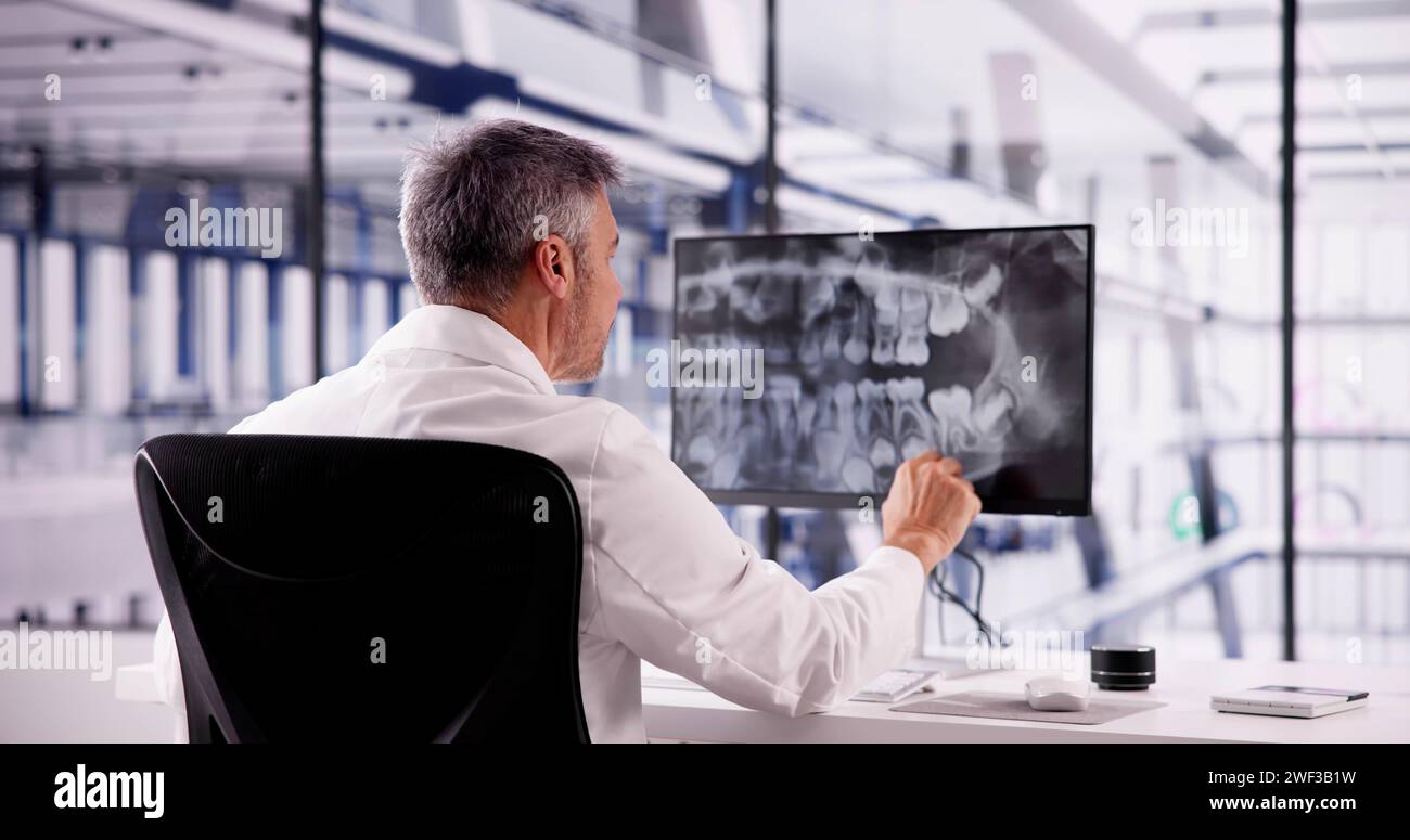 Dentist Doctor Looking At Teeth Xray On Computer Stock Photo - Alamy