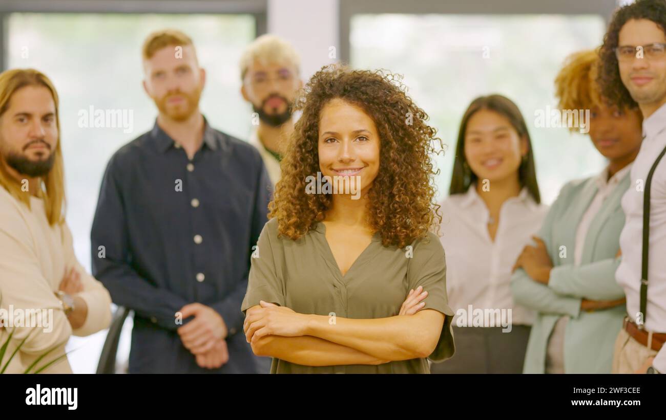 Woman leading a group of coworkers standing proud Stock Photo - Alamy
