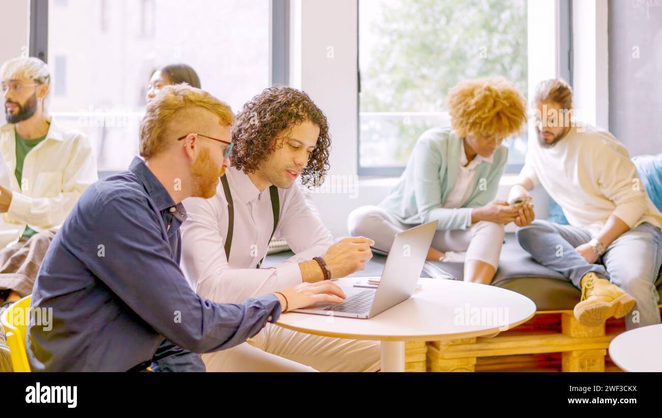 Modern coworking full of people working on teams Stock Photo - Alamy