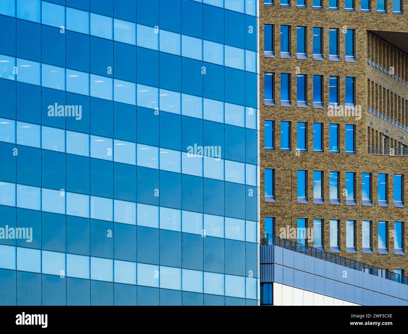 The image showcases the juxtaposition of modern glass facade against a ...