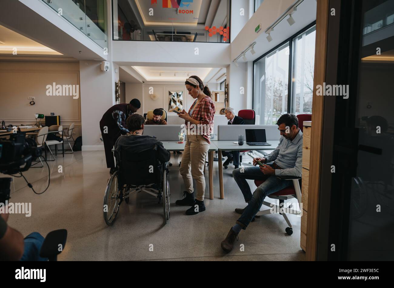 An inclusive modern workspace with employees engaging in tasks ...