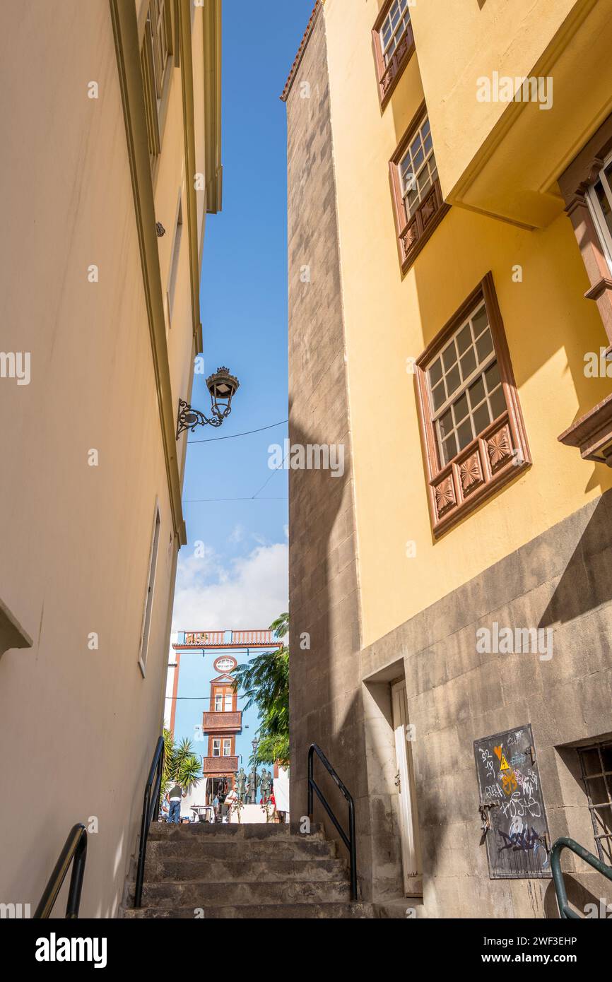 Narrow passage between white painted rendered buildings with steep ...