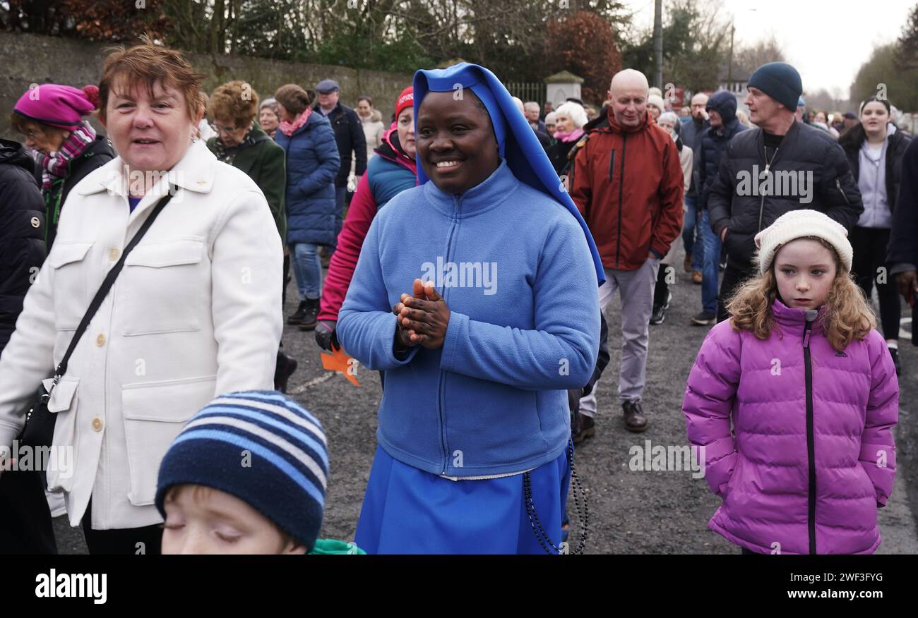 People take part in a procession to carry the relic of St. Brigid from ...