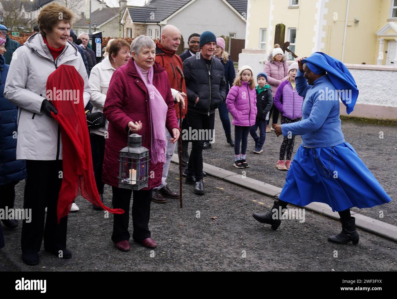 People take part in a procession to carry the relic of St. Brigid from ...