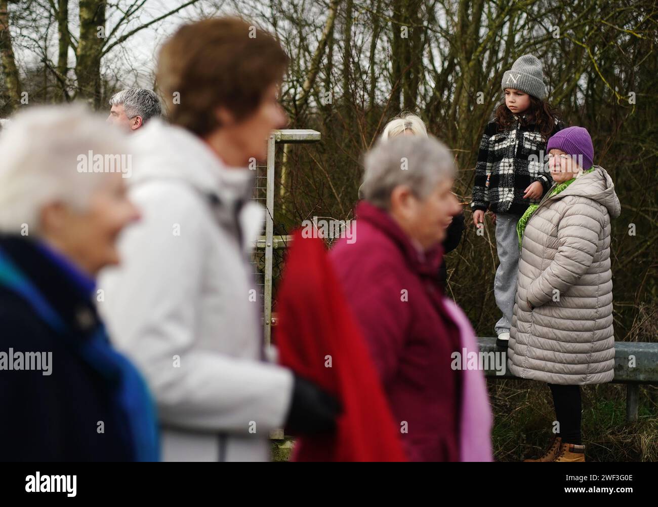People watch on as a relic of St. Brigid is carried during a procession ...