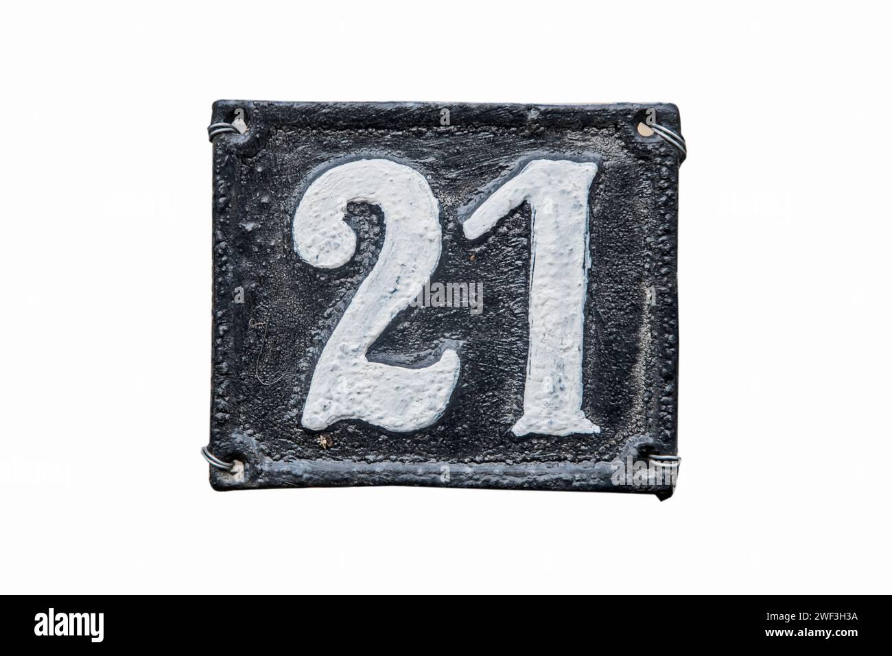 Old retro weathered cast iron plate with number 21 closeup isolated on ...