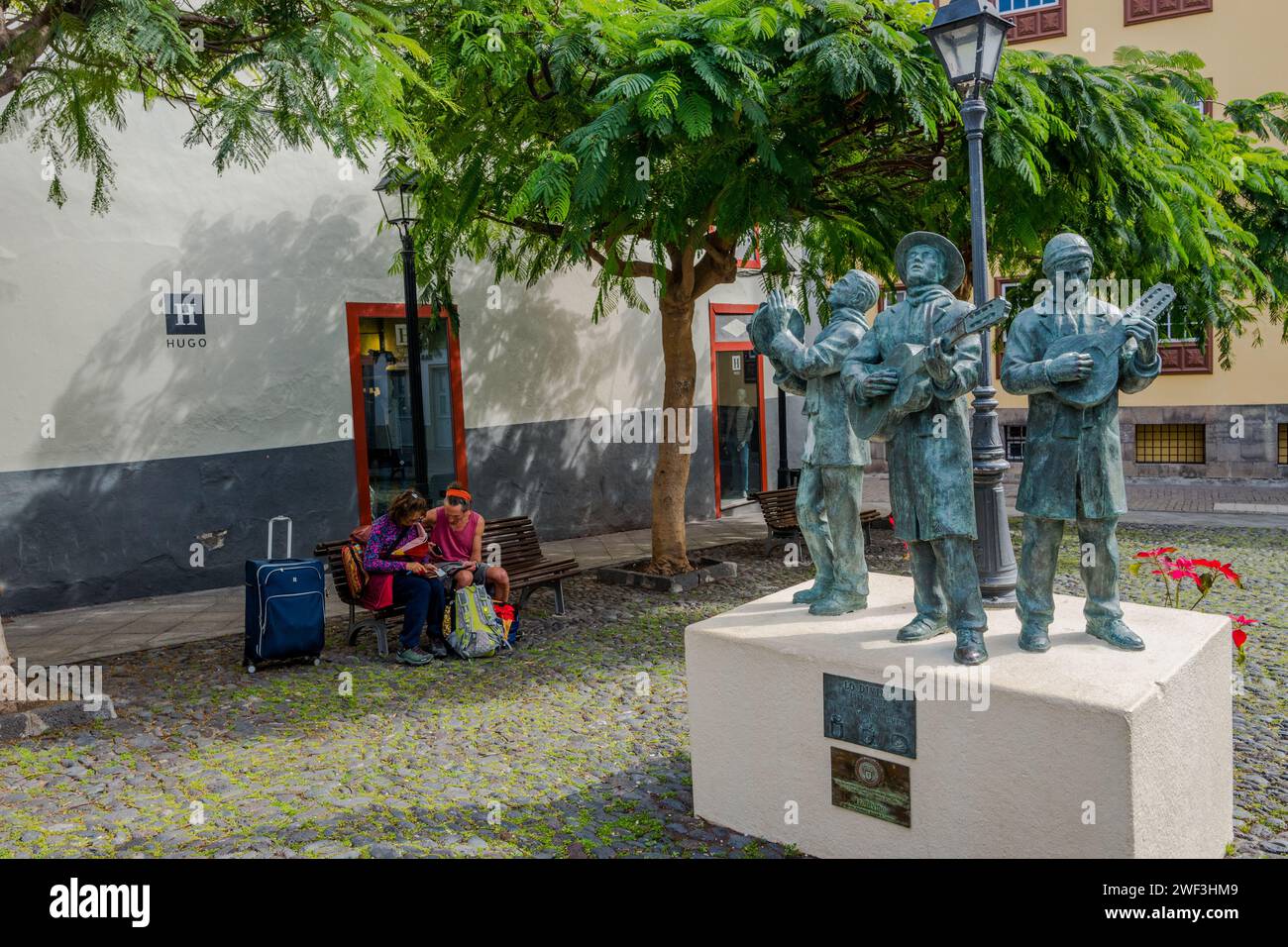 A Bronze statue of three male singers at the Plaza de Vandale, Santa ...
