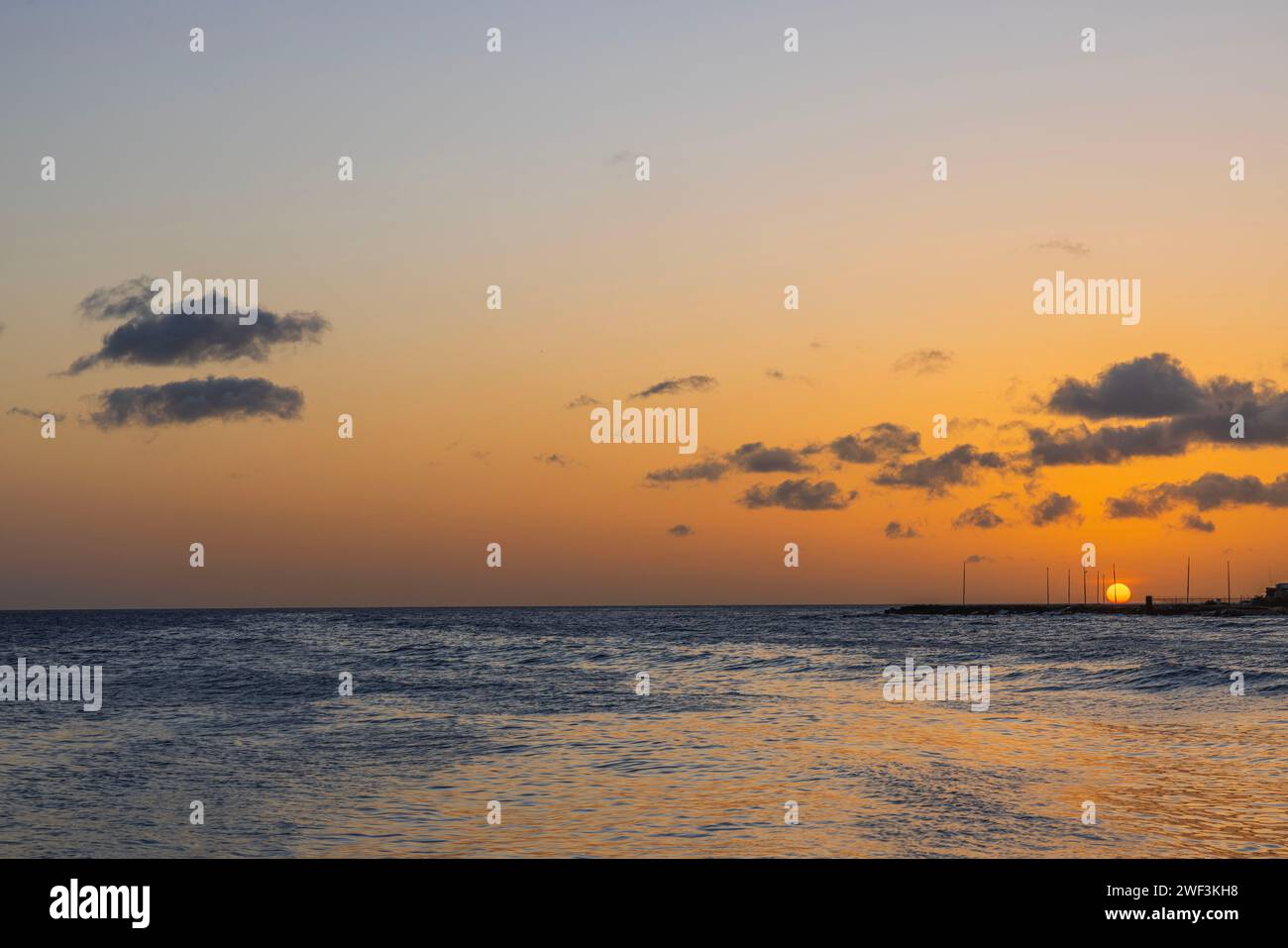 Captivating view of a orange sunset on island Curacao's horizon in the ...
