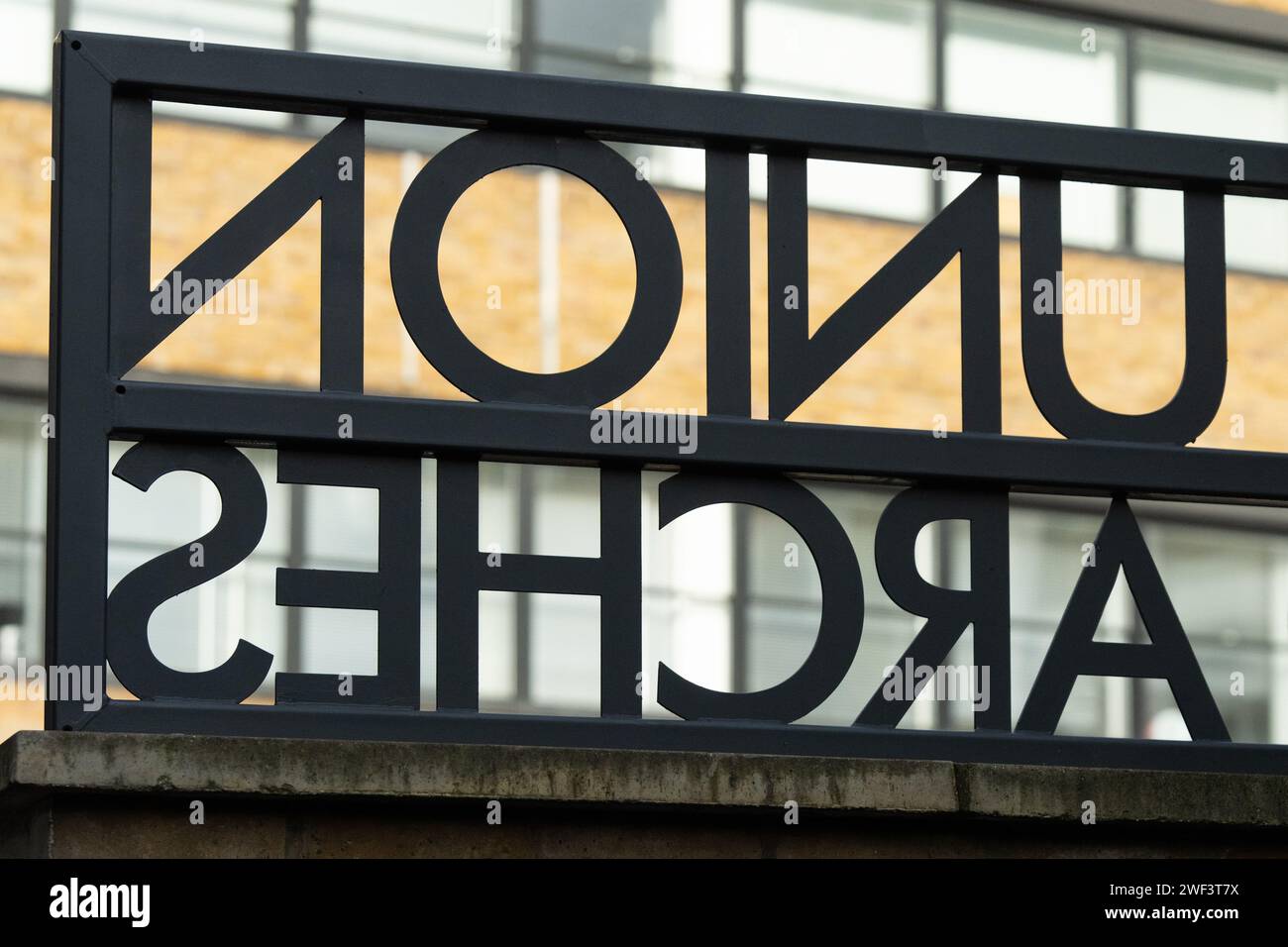 Black metal sign with the words "UNION ARCHES" against a blurred ...