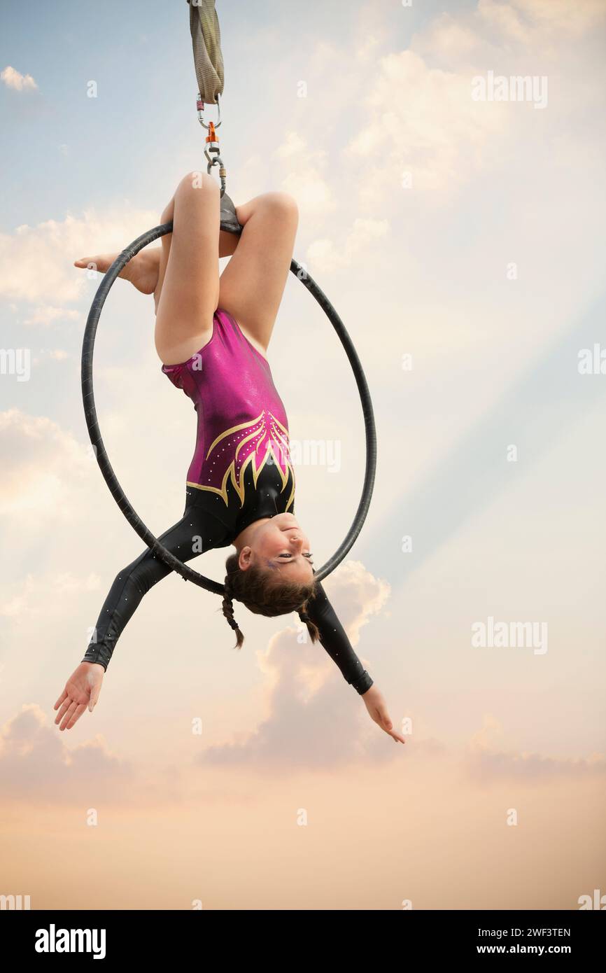 12 years old girl gymnast performing on aerial hoop outdoors Stock ...