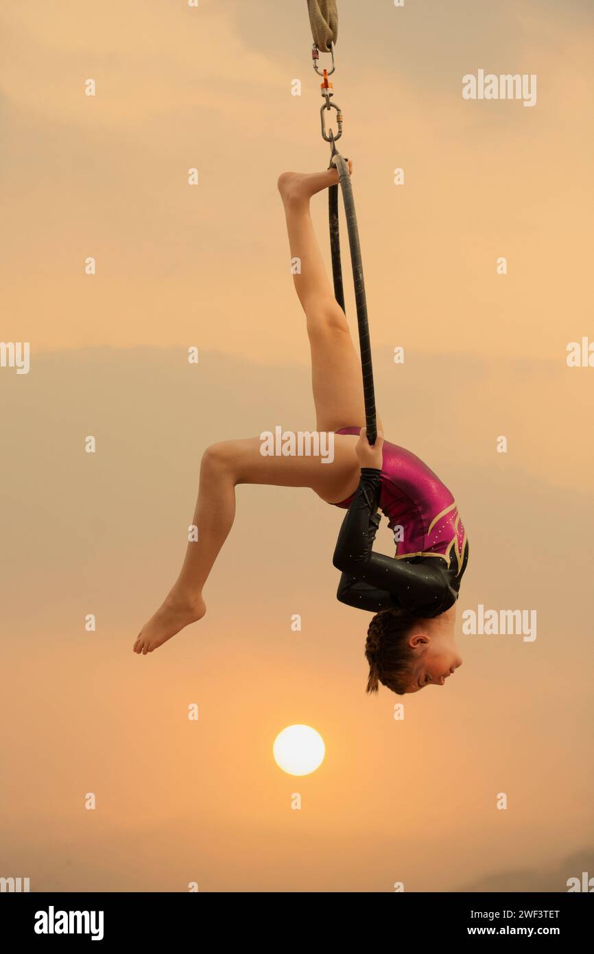 12 years old girl gymnast performing on aerial hoop outdoors Stock ...