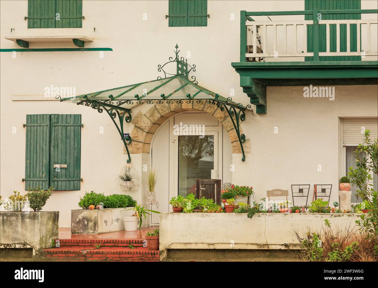 Unique green painted glass door canopy over a door Stock Photo - Alamy