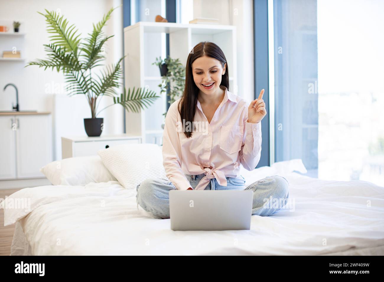 Portrait Of Woman Pointing Finger Up Sign Of Having Idea Working On