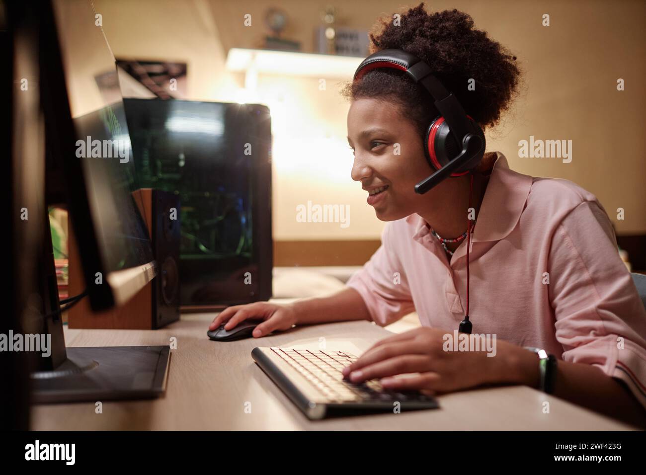 Side view portrait of excited teenage girl playing video games online ...