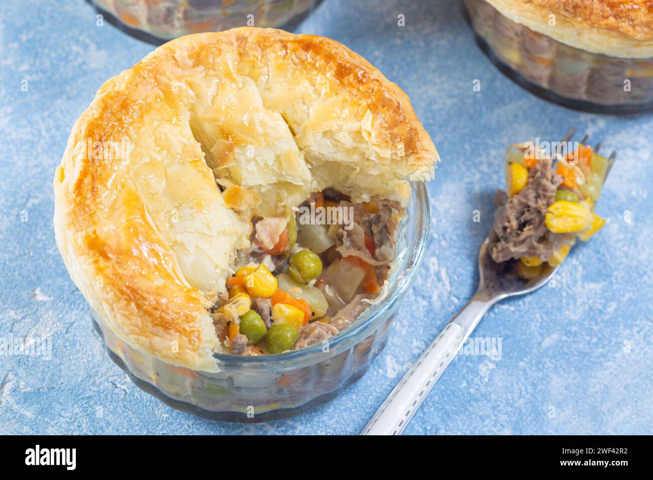 Individual beef pot pies or deep dish pies in ramekin, crust broken ...