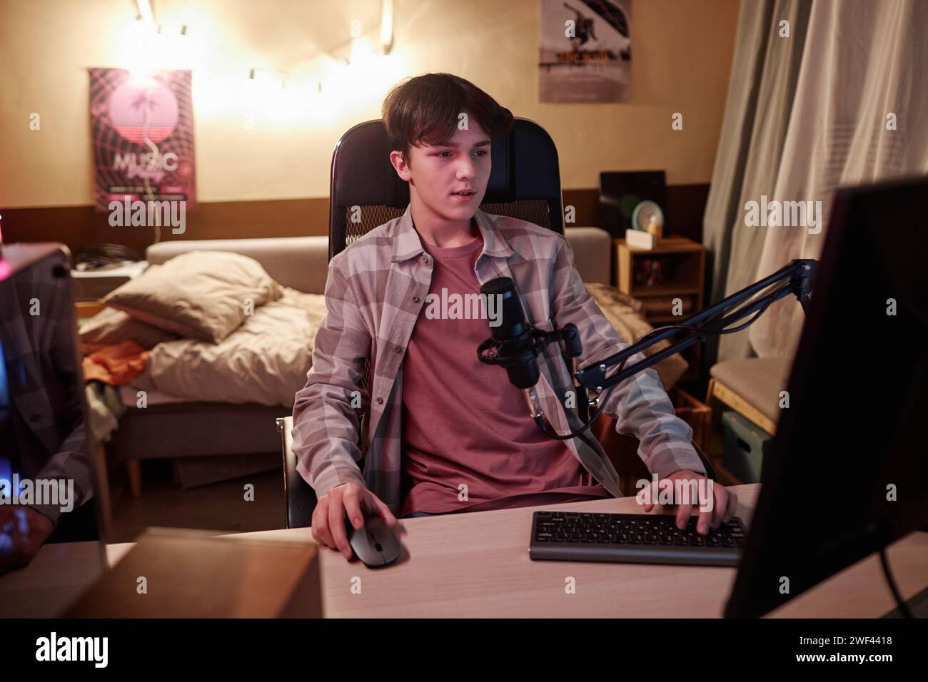 Wide angle view of teenage boy speaking to microphone while live ...