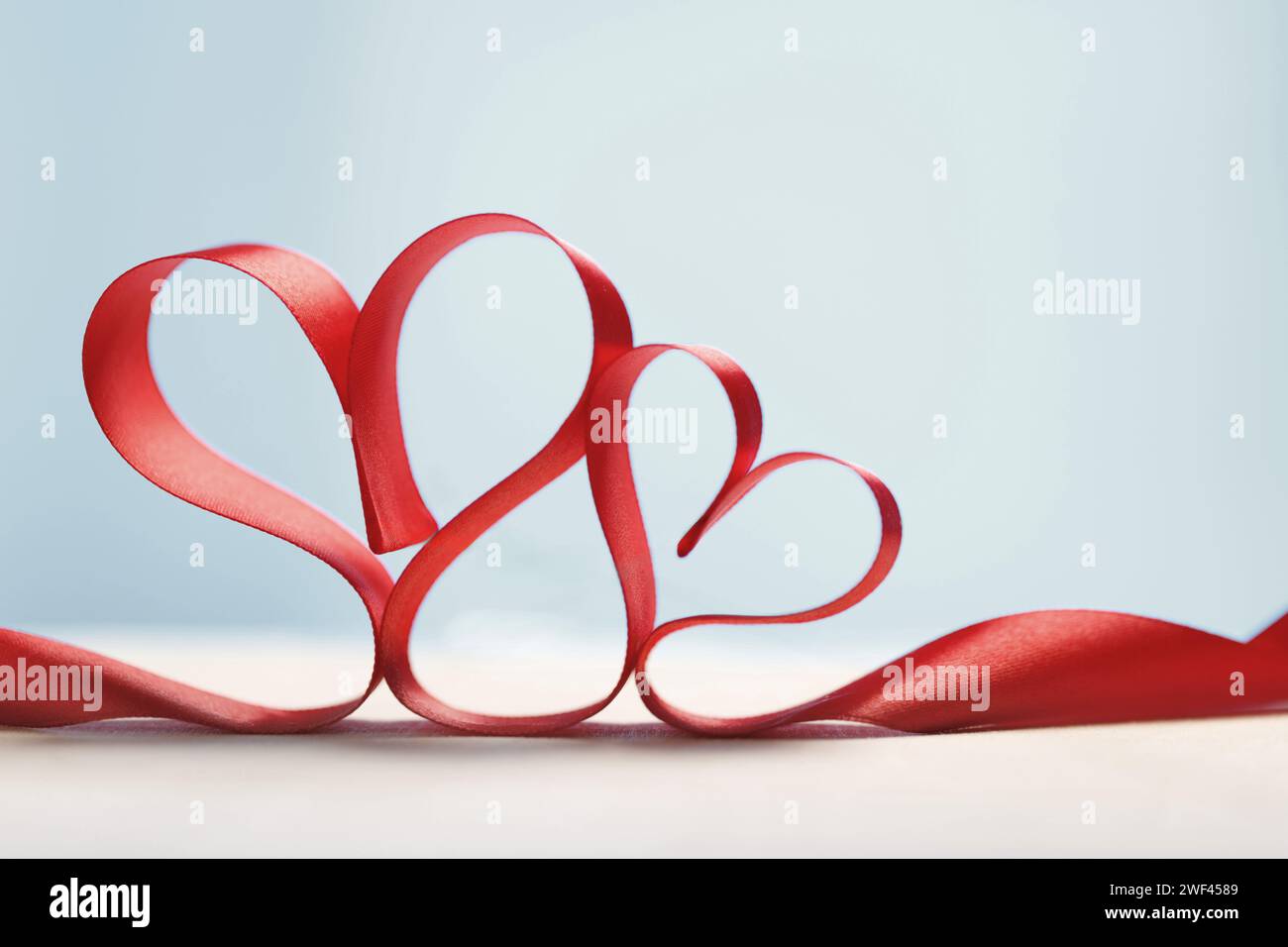 Hearts made from red ribbon. Valentine's card Stock Photo - Alamy