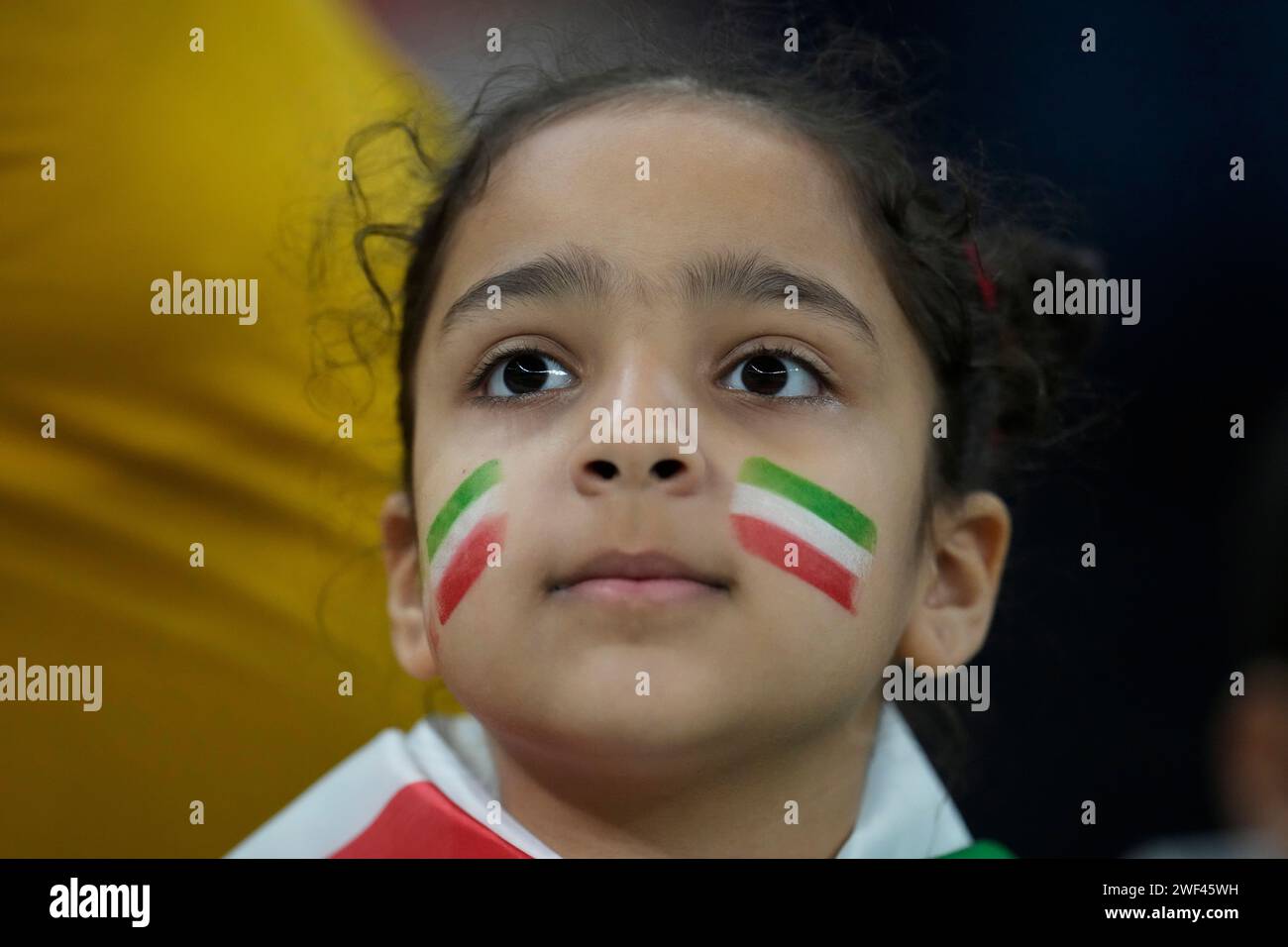 A young fan has her face painted with the Tajikistan's flag prior to ...