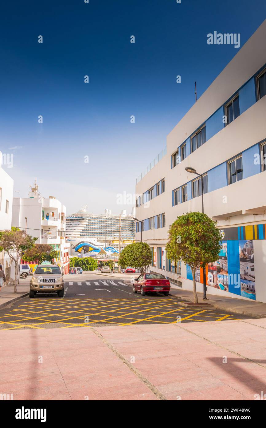 Bright colourful Spanish street and with the Aida Cosma cruise liner ...