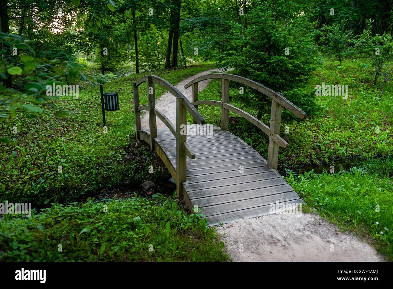 Cute small touristic wooden bridge over the creek in the Smiltene Old ...