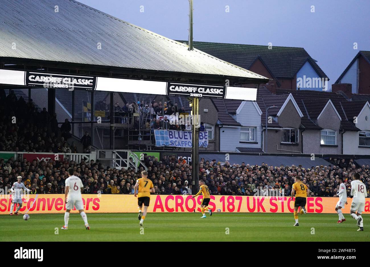 Fans watch the match from a scaffold outside the ground during the ...