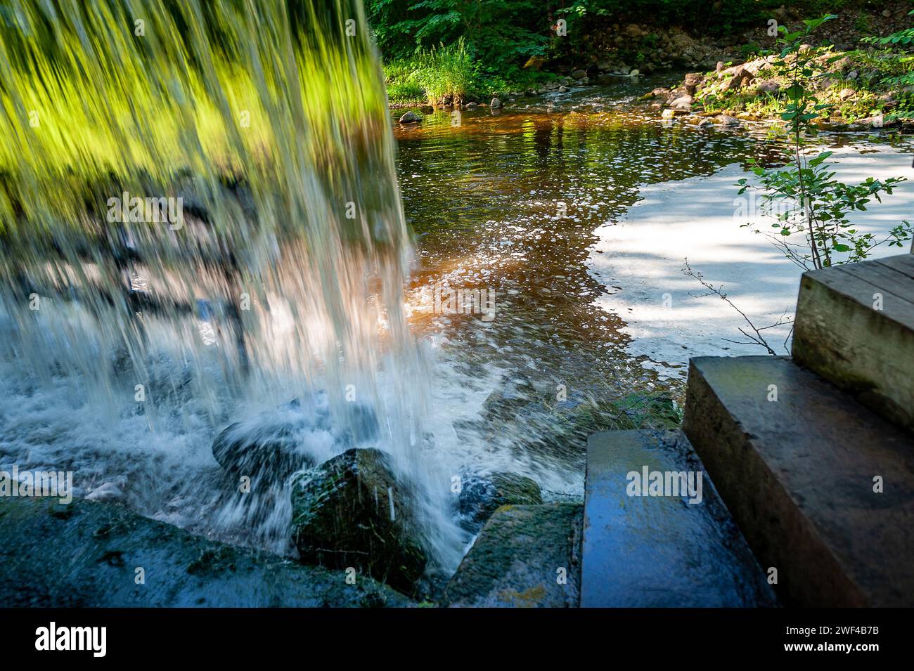 Passage under an artificial waterfall. Wall of water, falling cascade ...