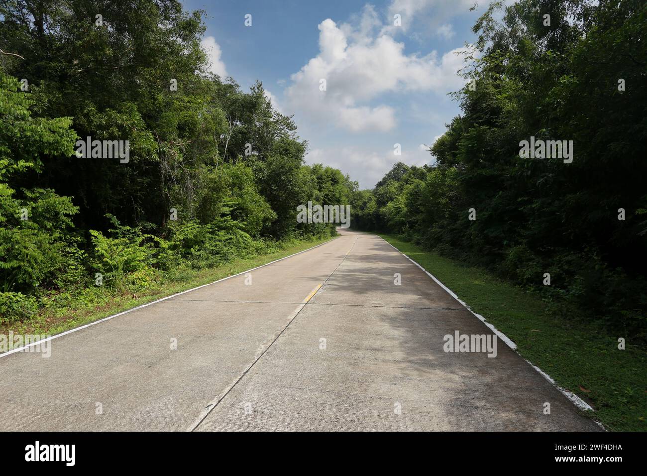Concrete road during daytime with blue sky view in the background and ...