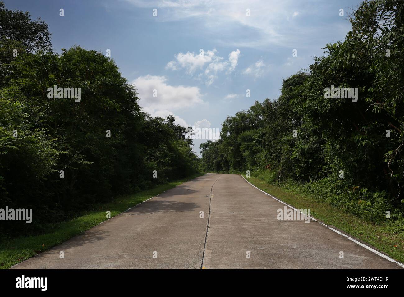 Concrete road during daytime with blue sky view in the background and ...