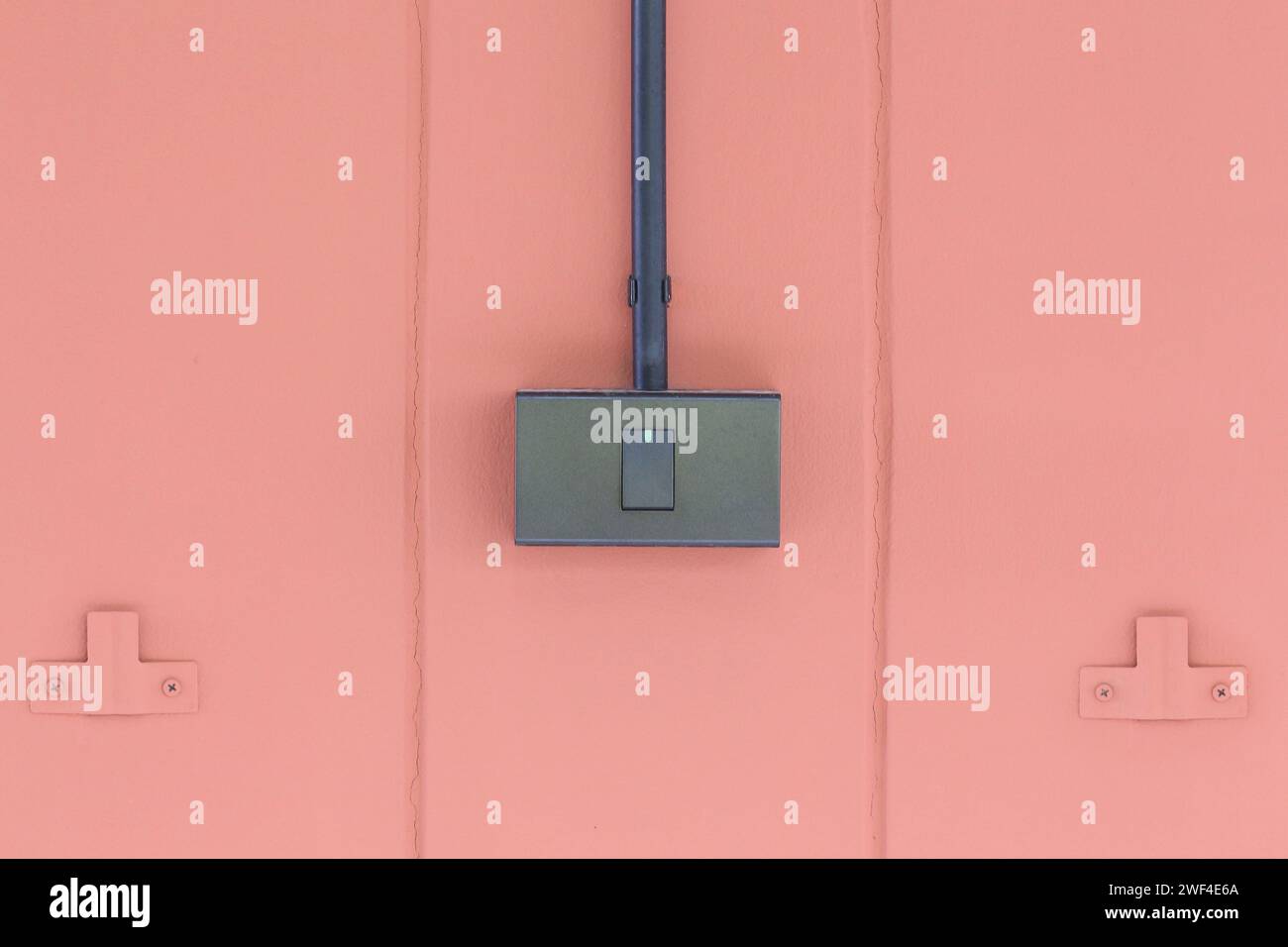 Old power plug on pink concrete wall of house and empty space for ...