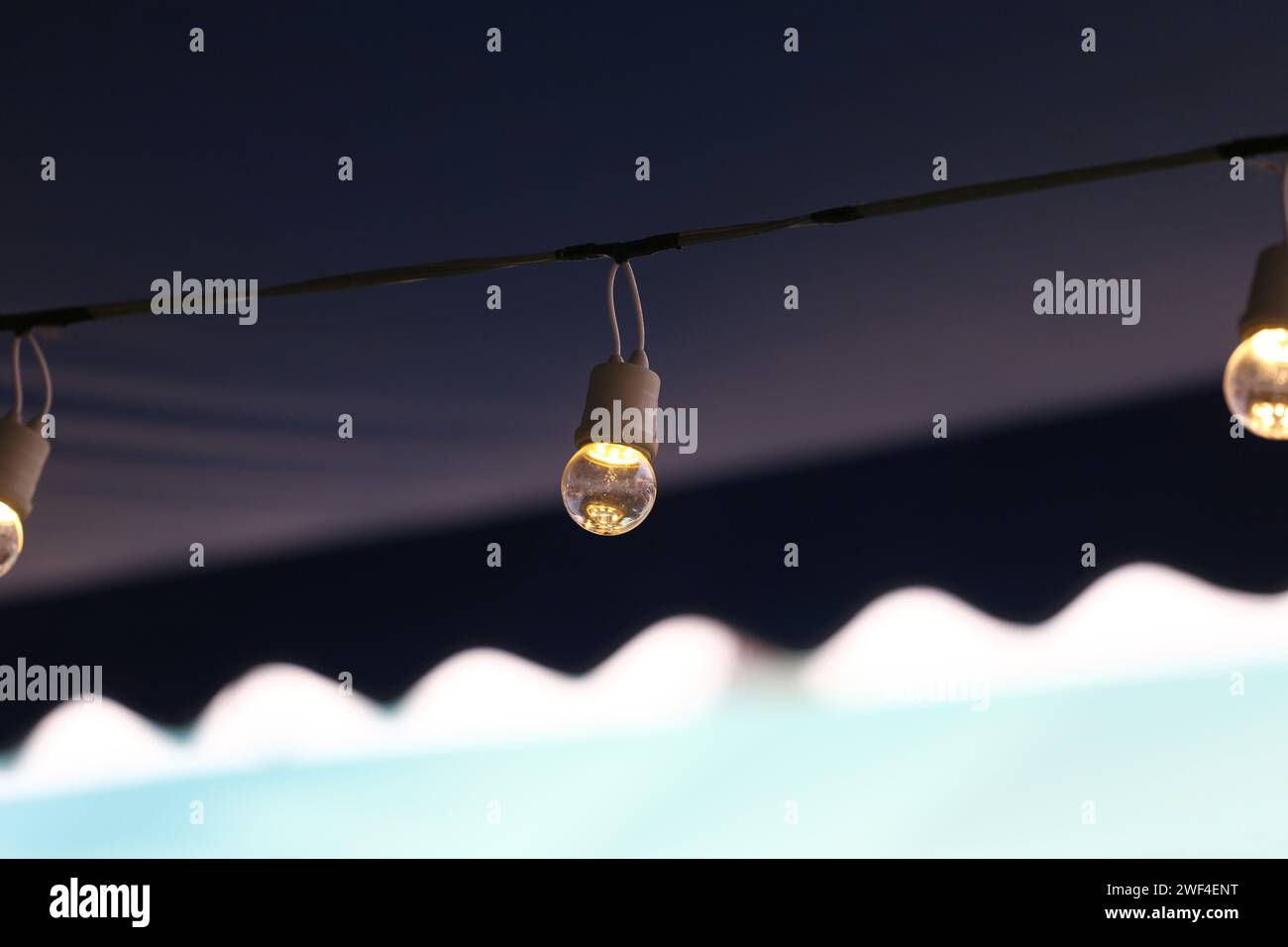 A light bulb hanging on the railing, Hanging bulb set with multiple ...