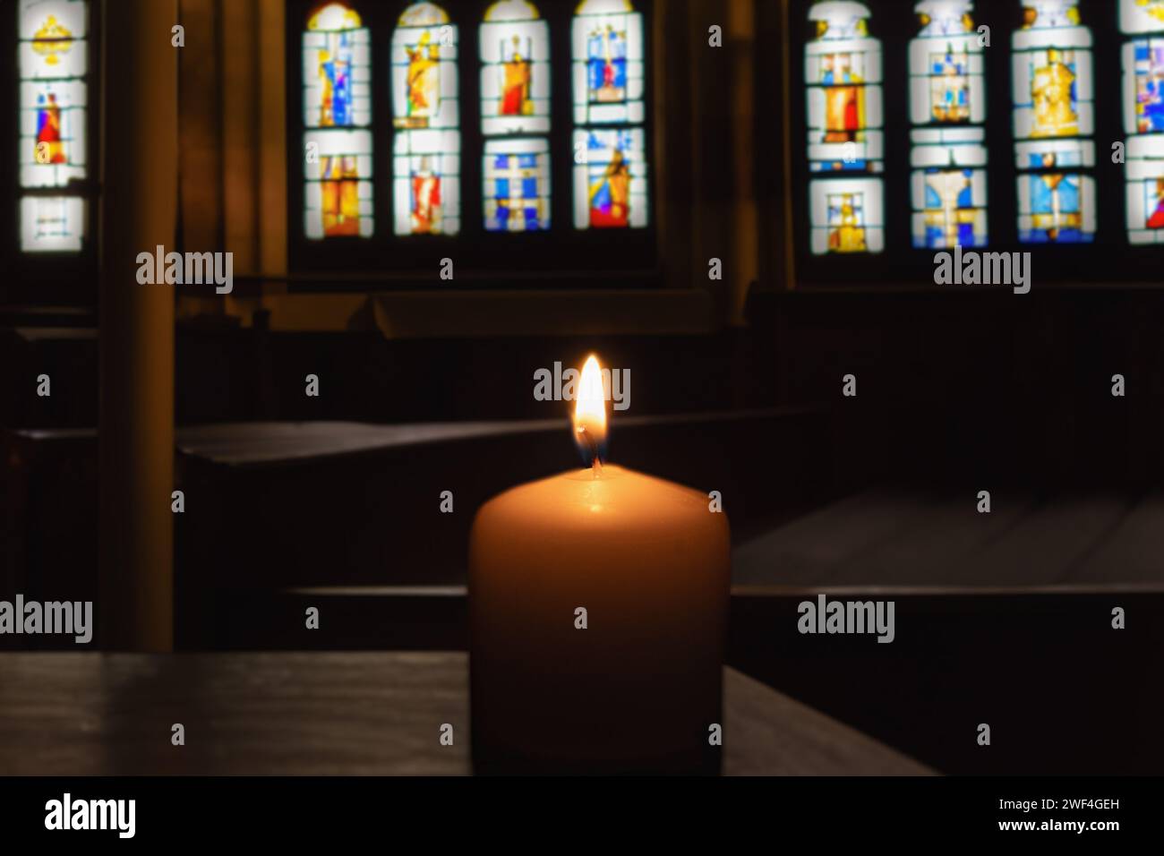 A candle burns on a dark background. Enlarged image of a candle in the ...