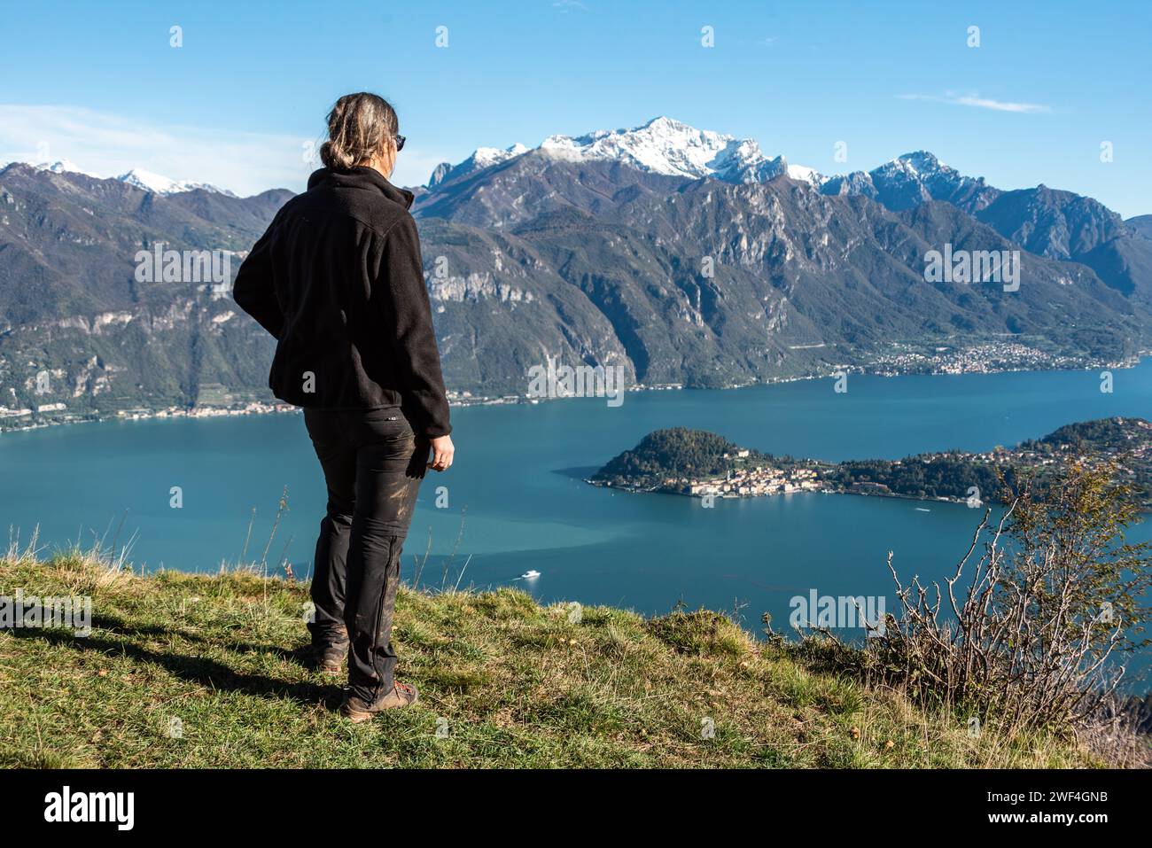 A hiker enjoying the magnificent view of Bellagio at lake Como seen ...