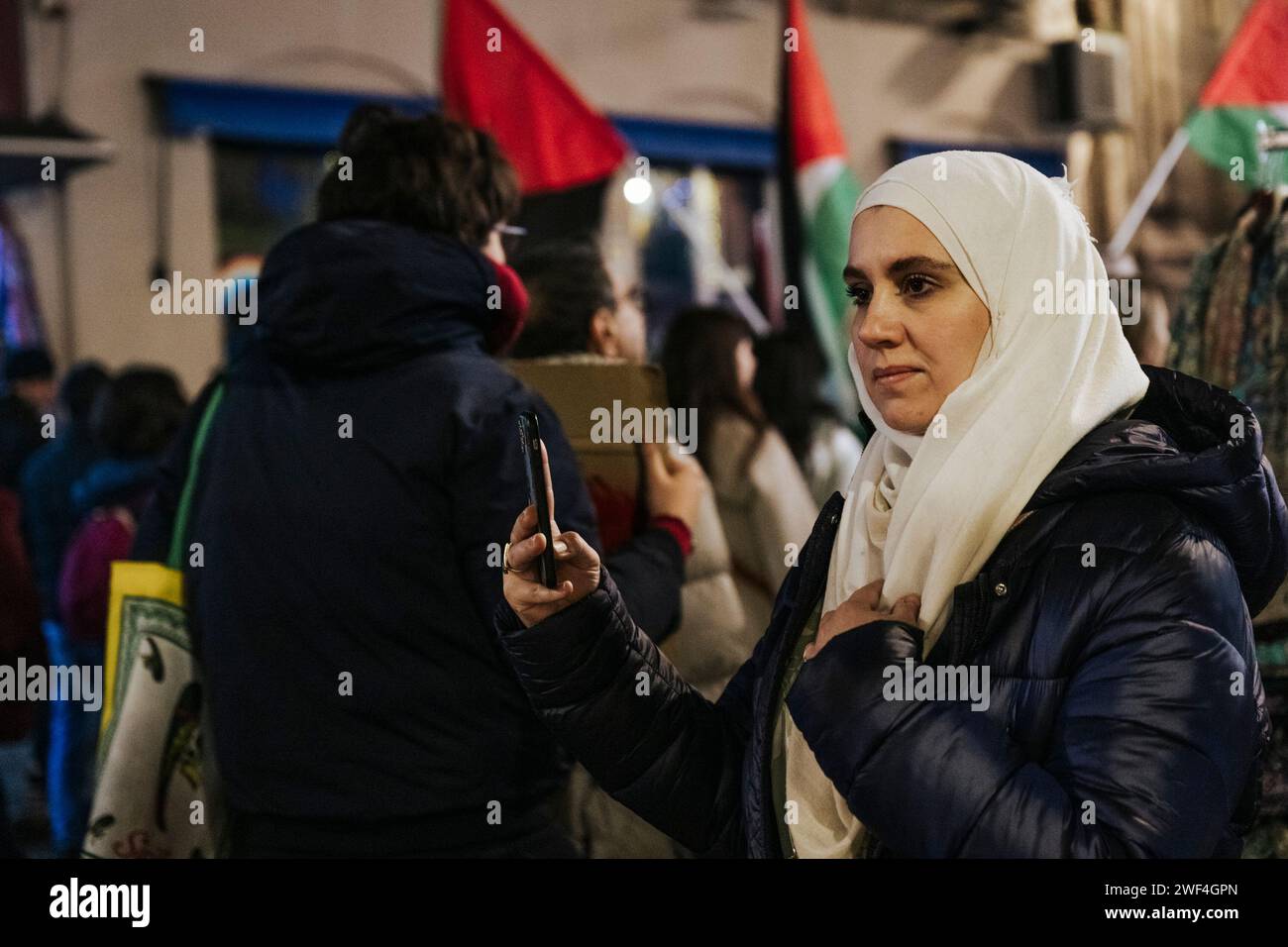 Palermo, Italy. 13th Jan, 2024. A Muslim woman takes photos during a ...