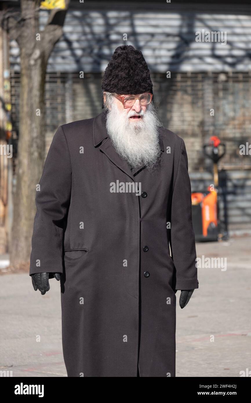 An older orthodox Jewish man walks on Lee Avenue wearing a karakul ...