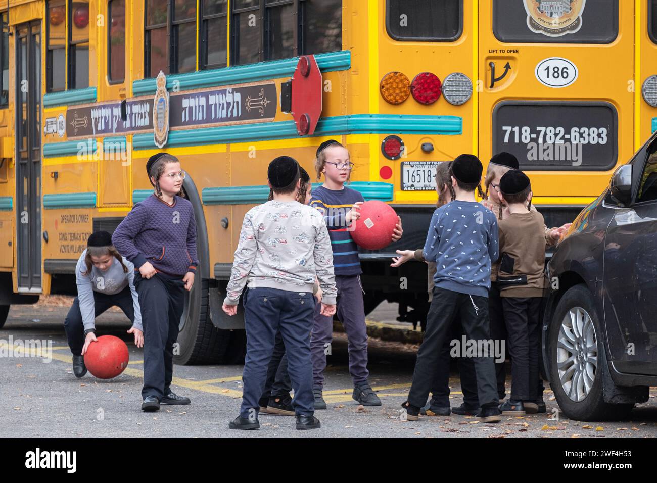 Recess at a Yeshiva where orthodox Jewish boys play on a city street ...