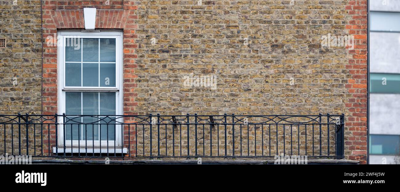classic white windows of typical London architecture with red brick ...