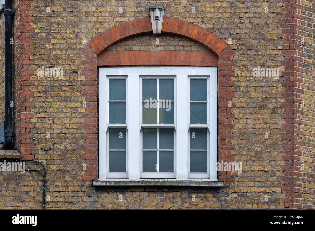 classic white windows of typical London architecture with red brick ...