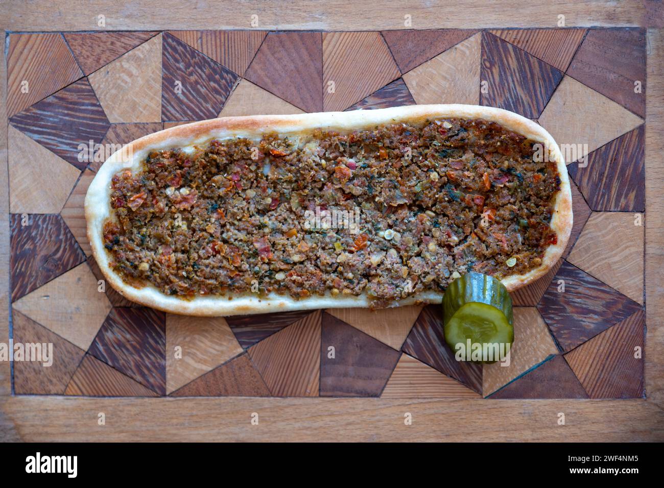 Arabic stuffed pastries on arabesque wooden background Stock Photo - Alamy