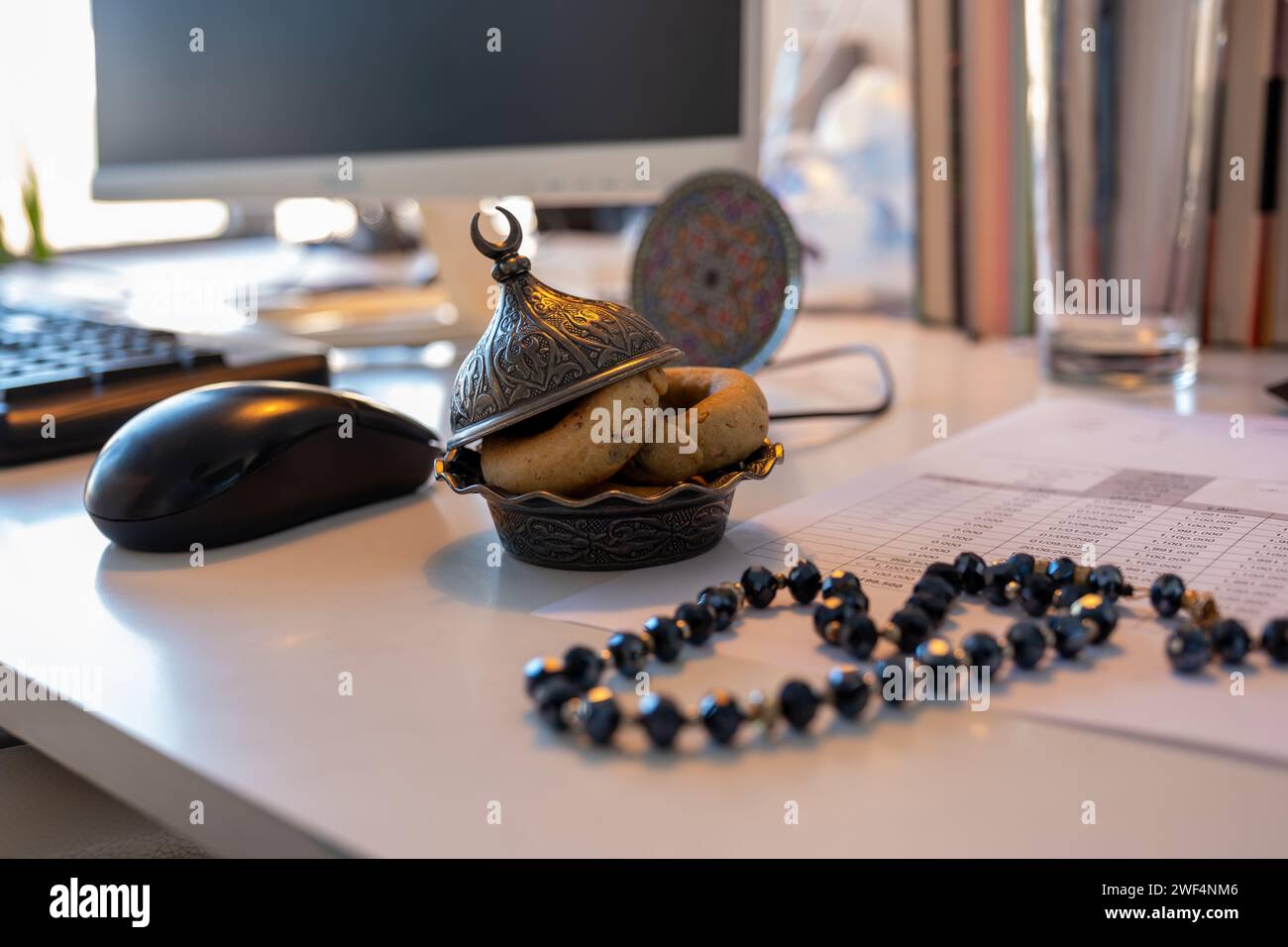 arabic sweets on office desk with quran and rosary Stock Photo - Alamy
