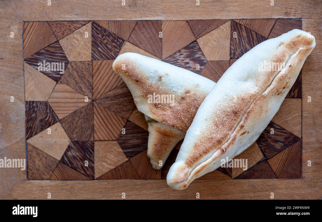 Arabic stuffed pastries on arabesque wooden background Stock Photo - Alamy