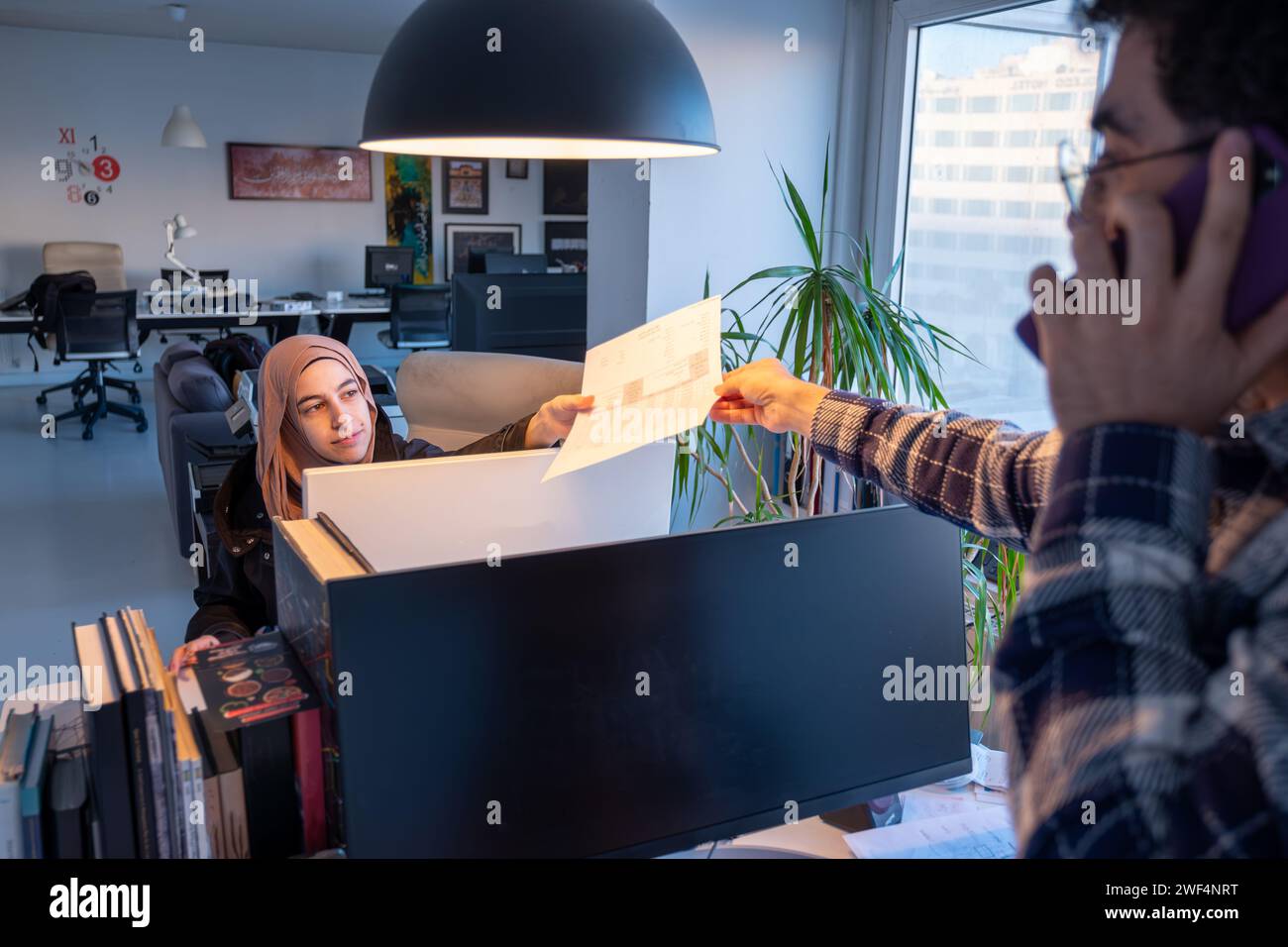 Muslim female working in office using computer with white background ...