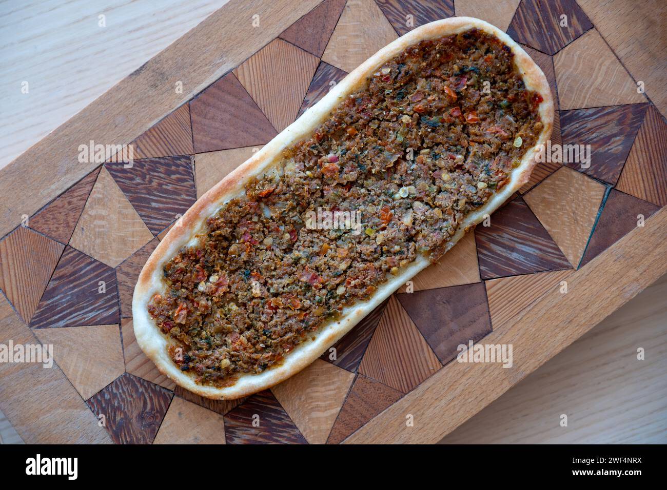 Arabic stuffed pastries on arabesque wooden background Stock Photo - Alamy