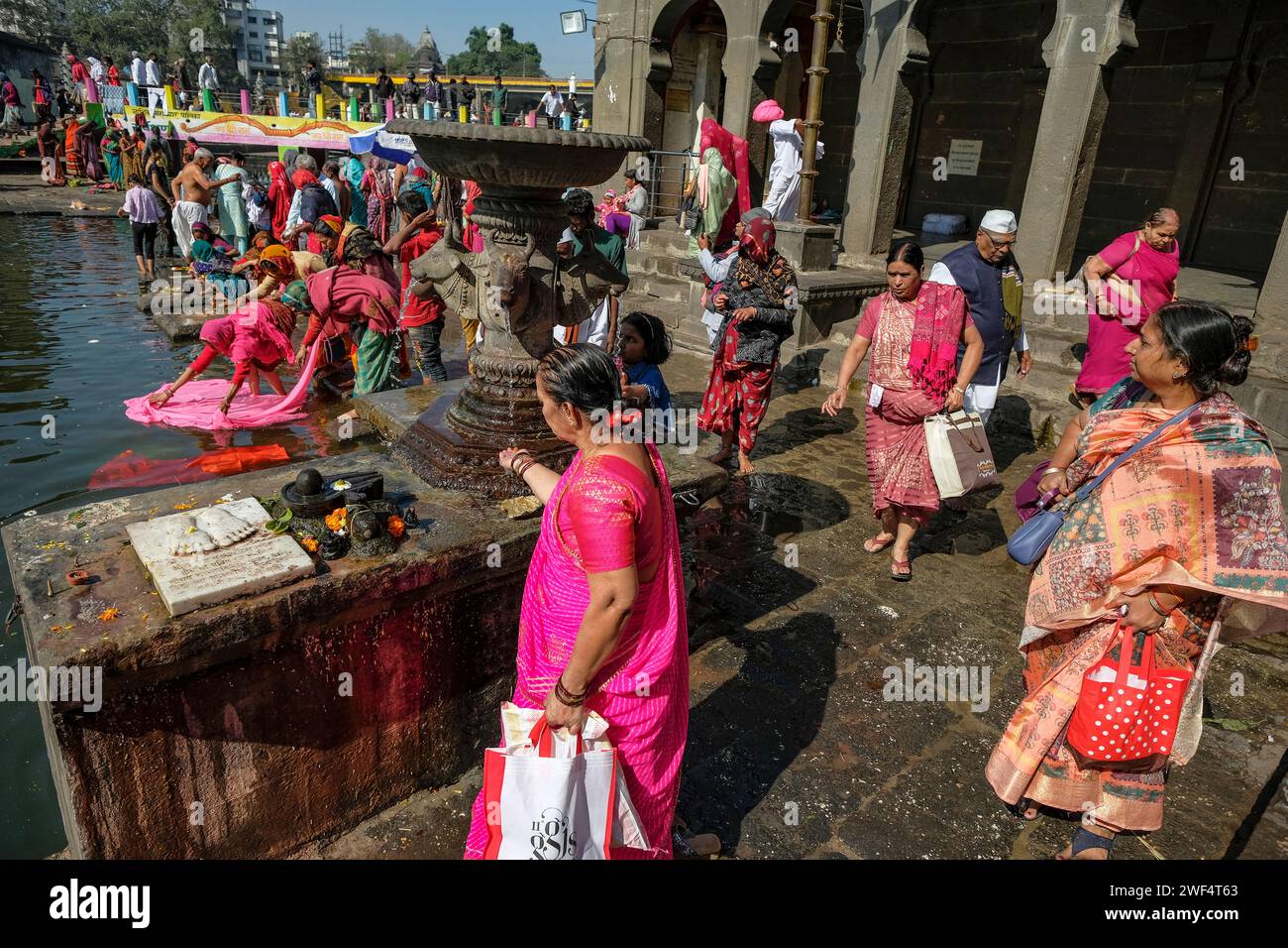 Nashik, India - January 25, 2024: Women making offerings at the Ganga ...