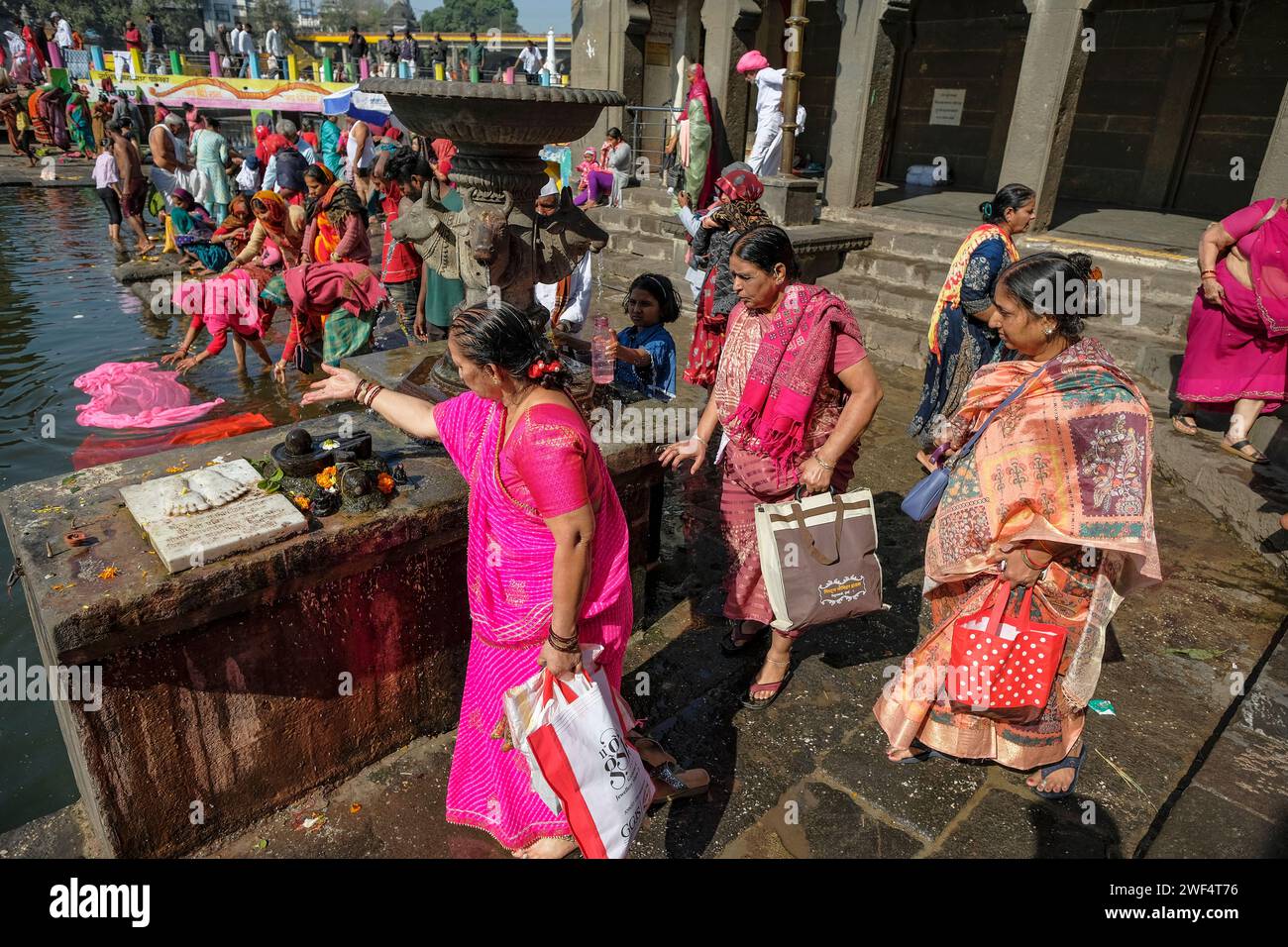 Nashik, India - January 25, 2024: Women making offerings at the Ganga ...