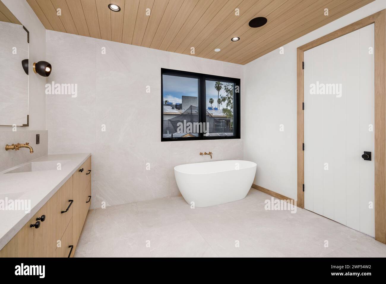Empty bathroom with large sink and waterfront view through window Stock Photo - Alamy