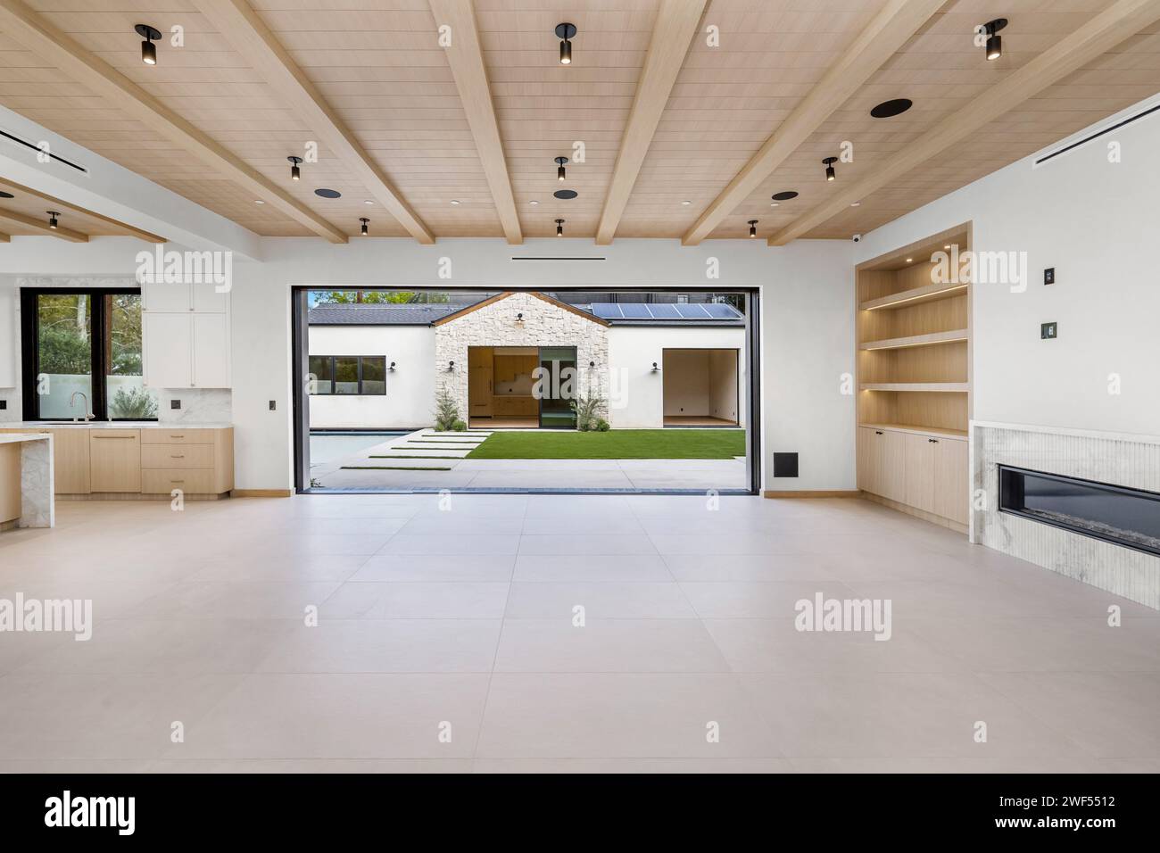 Open white house with stylish hardwood wall accents Stock Photo - Alamy