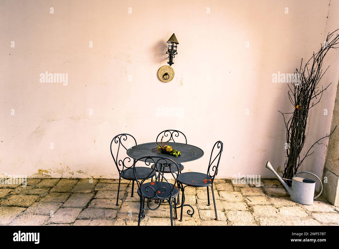 Cozy Italian courtyard with an iron table, colorful Italian towns in ...