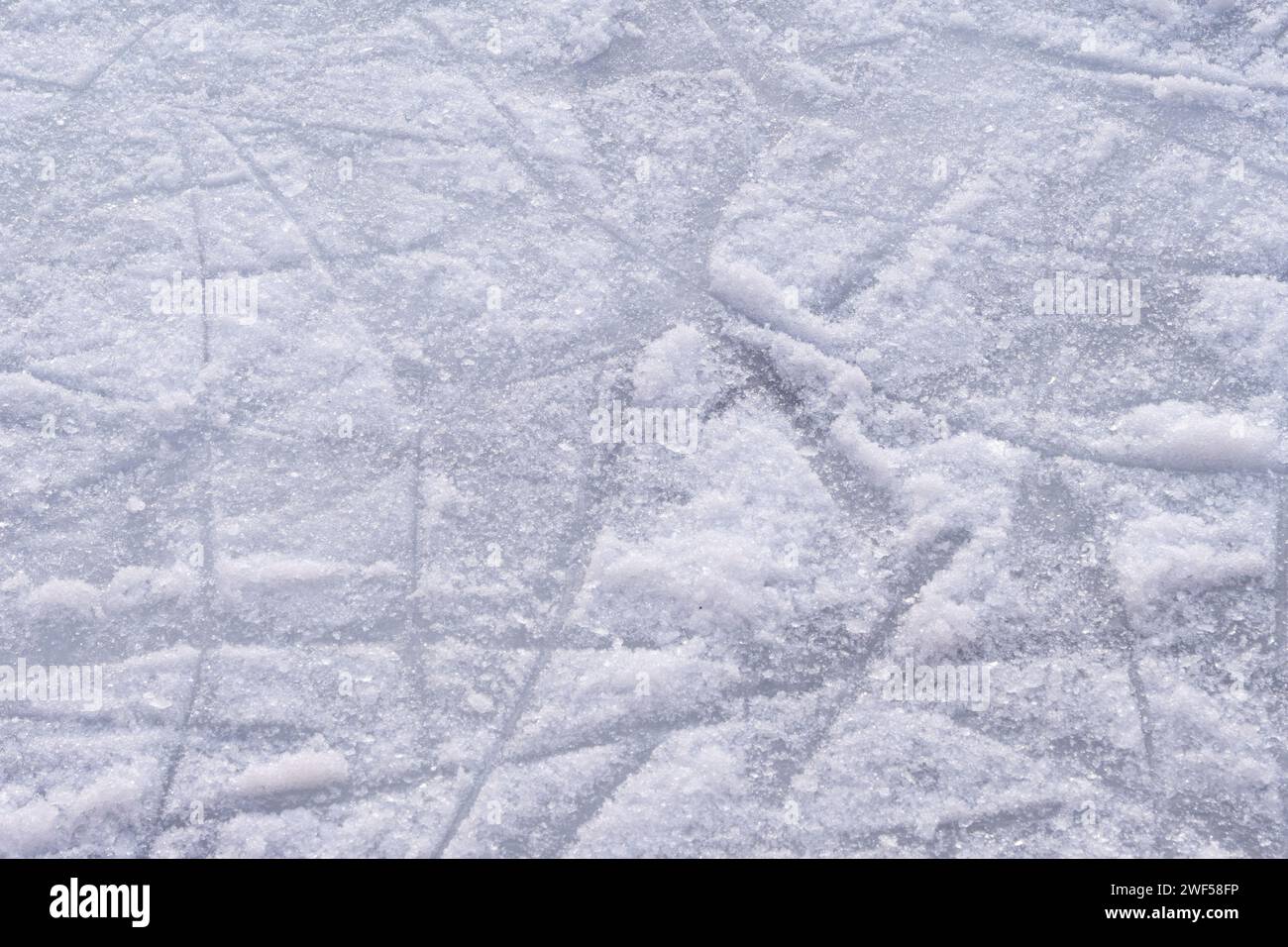 A detailed photo of an ice skating rink's scratched surface texture ...