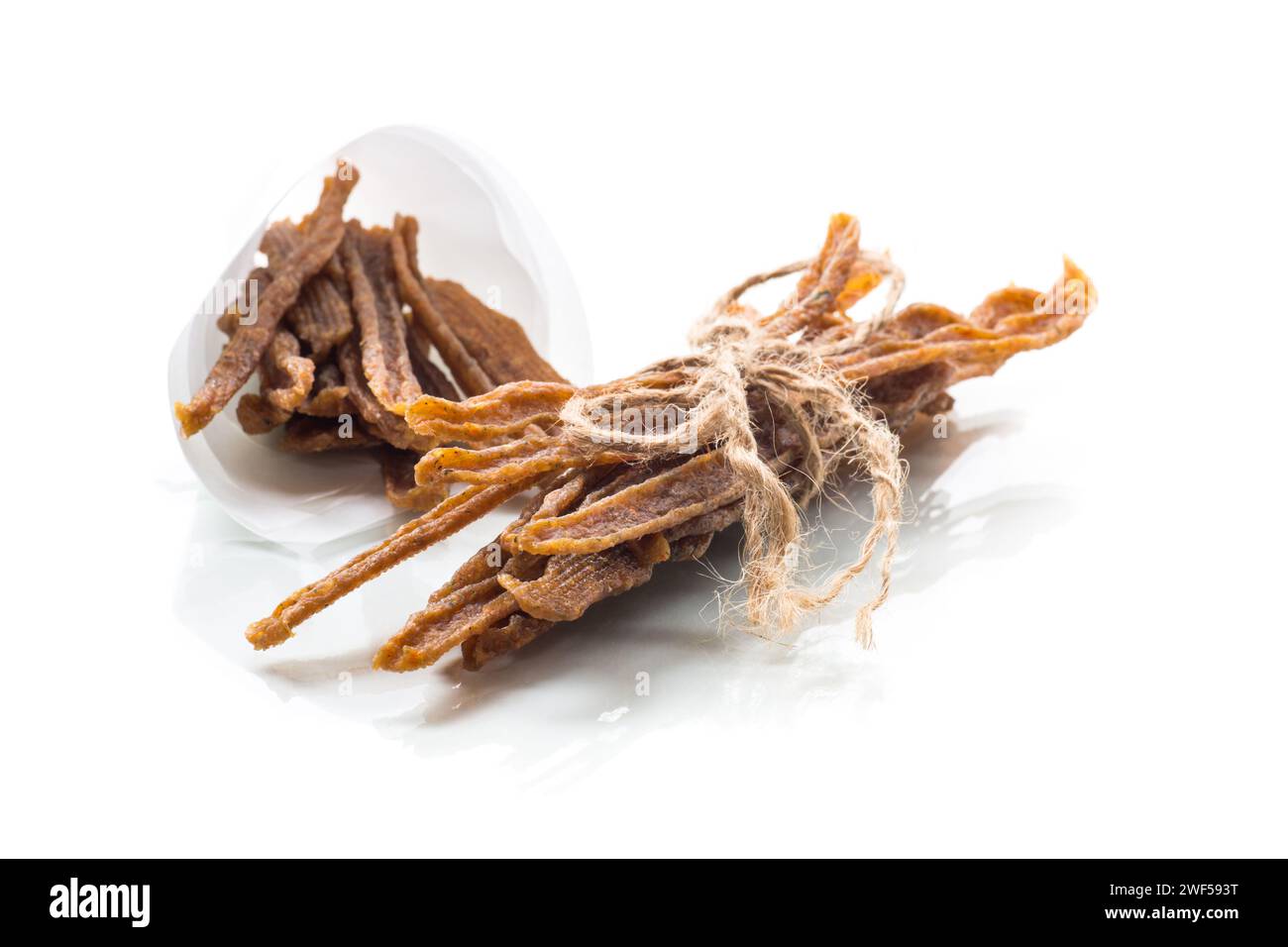 A handful of dried chicken meat, marinated with spices, isolated on a ...