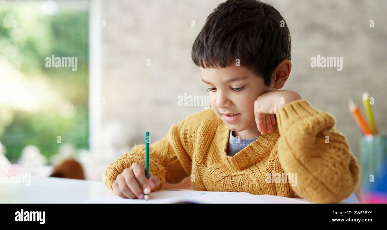 Child, drawing or boy writing homework on notebook in kindergarten ...